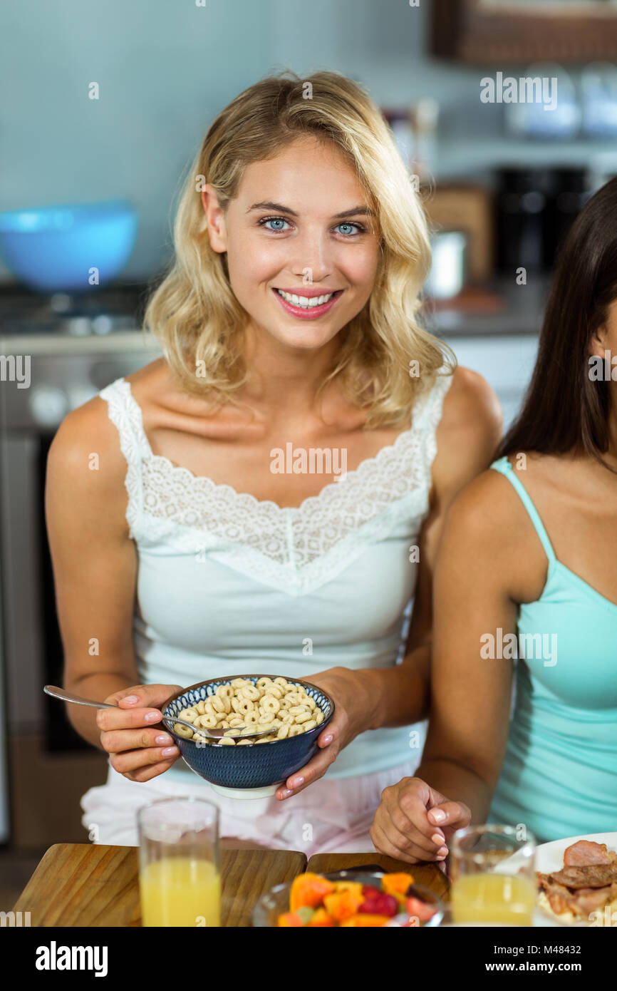 Beautiful woman smiling while having breakfast at home Stock Photo - Alamy