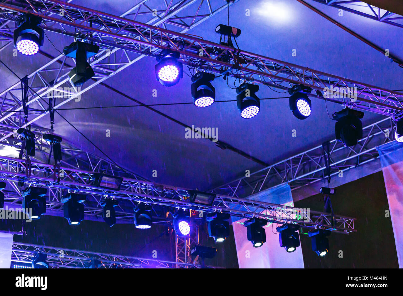 blue stage spotlights during the rain Stock Photo - Alamy
