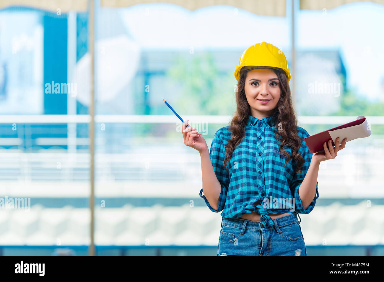 Woman builder taking notes at construction site Stock Photo - Alamy