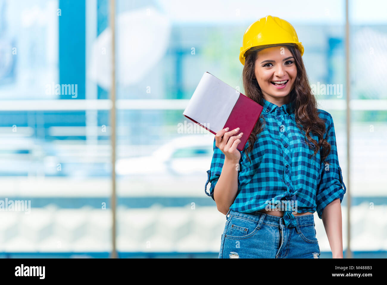 Woman builder taking notes at construction site Stock Photo - Alamy