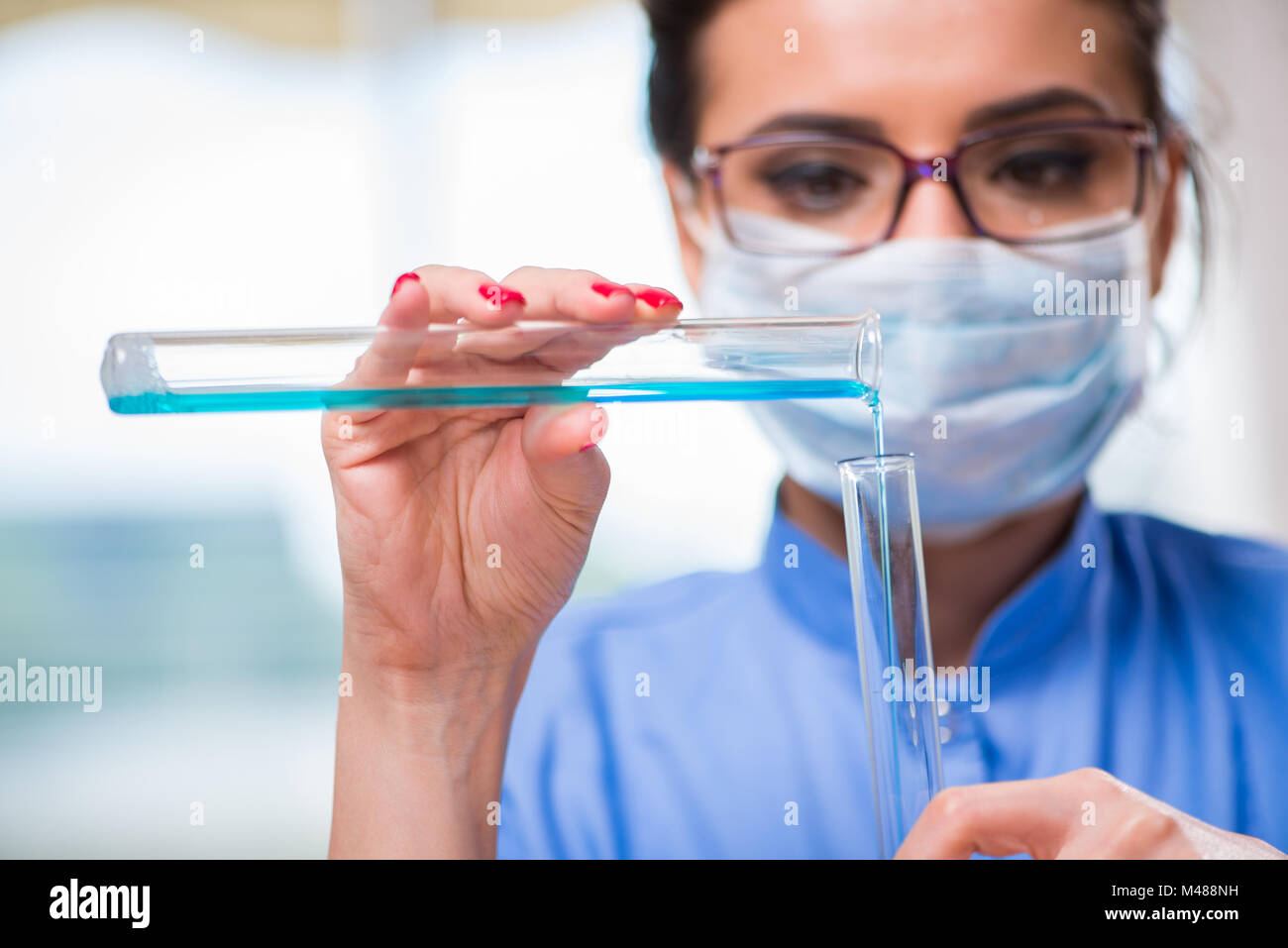 Woman doctor doing chemical tests in laboratory Stock Photo - Alamy