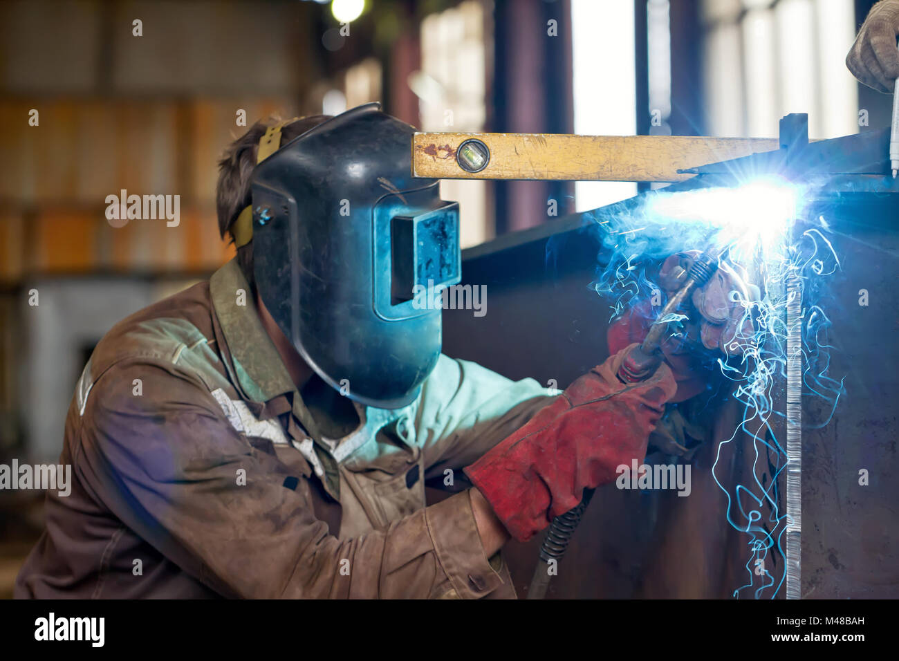 Semi-automatic welding of metal structures in the shop Stock Photo - Alamy