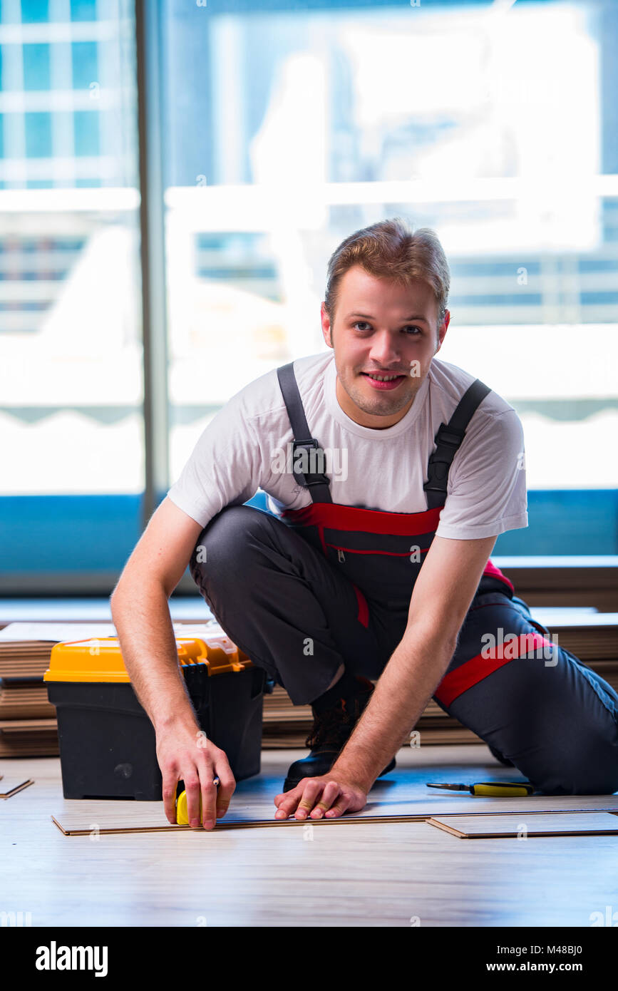 Man laying laminate flooring in construction concept Stock Photo - Alamy