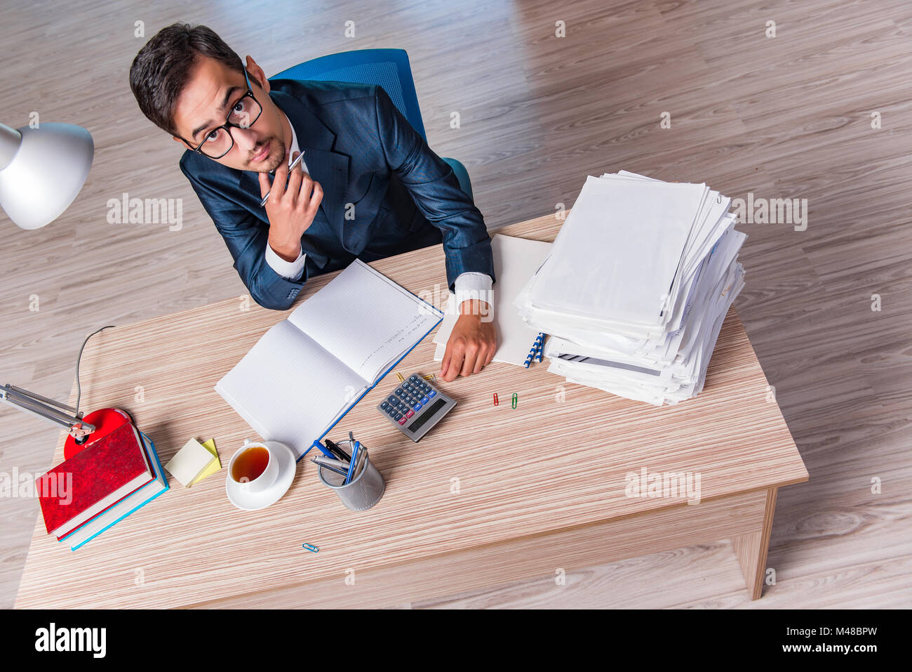 Young businessman in stress with lots of paperwork Stock Photo - Alamy