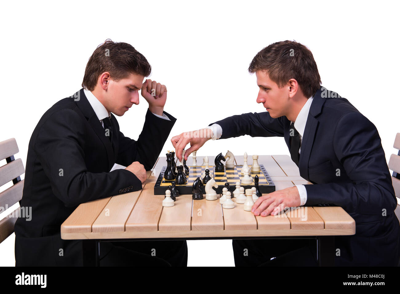 Twin brothers playing chess isolated on white Stock Photo - Alamy