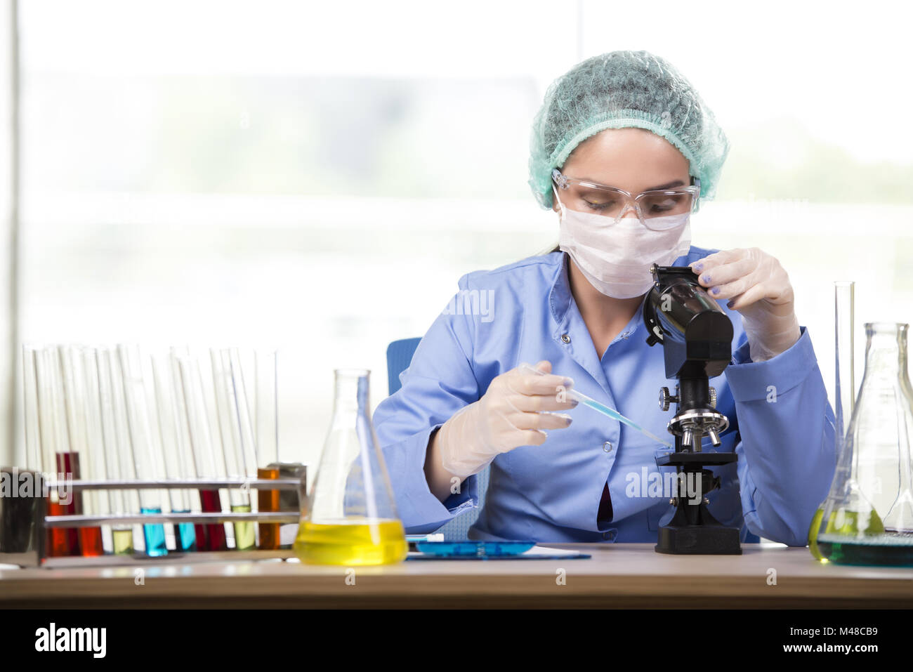 Experienced lab assistant working on chemical solutions Stock Photo - Alamy