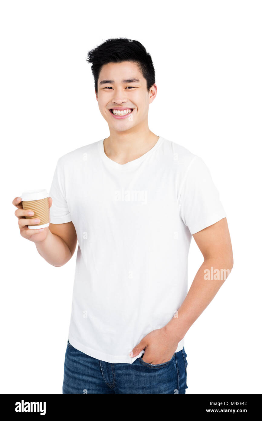 Happy man holding disposable coffee cup smiling at camera Stock Photo ...
