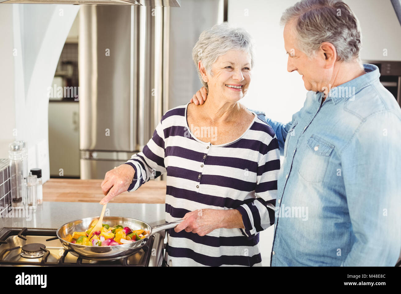 Caucasian elderly couple cooking romantic hi-res stock photography and ...