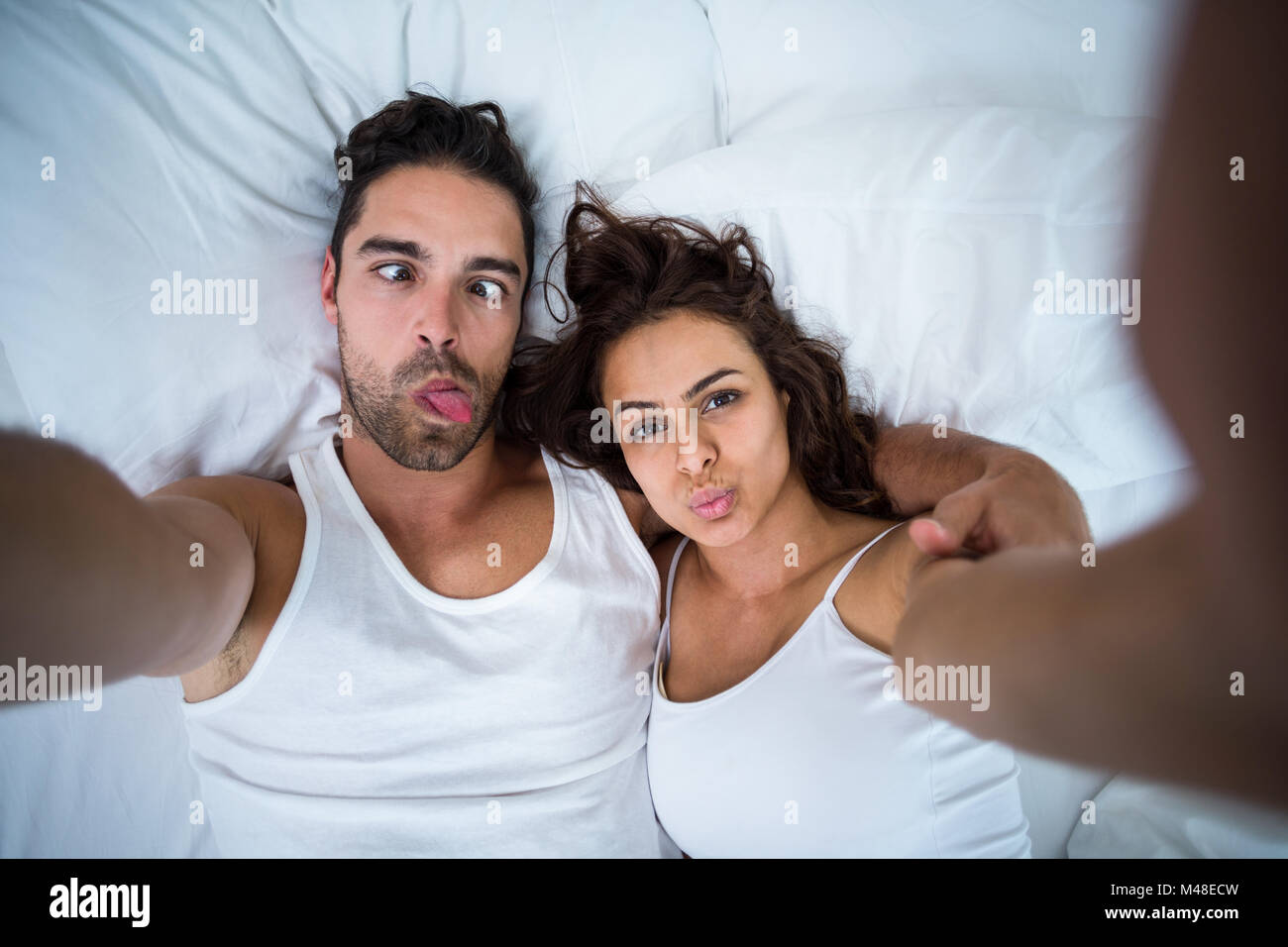 Couple making faces while taking self portrait Stock Photo - Alamy