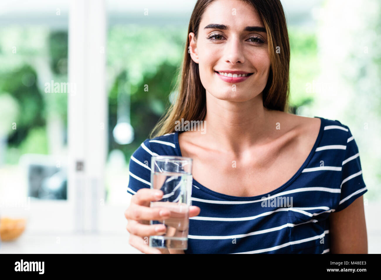 Smiling young woman drinking water hi-res stock photography and images ...