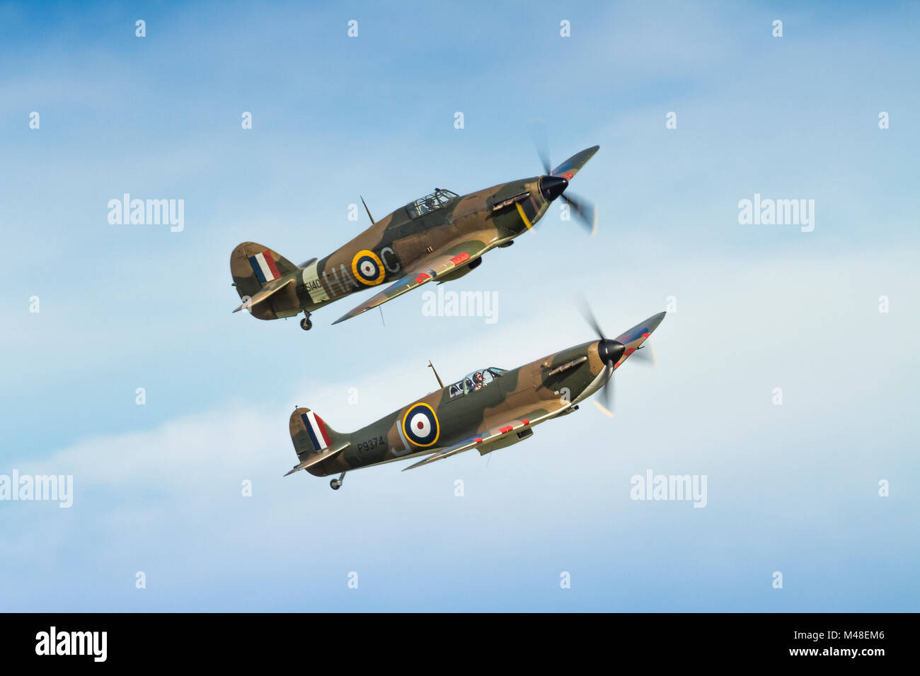 A Hawker Hurricane and Supermarine Spitfire flying in formation Stock ...