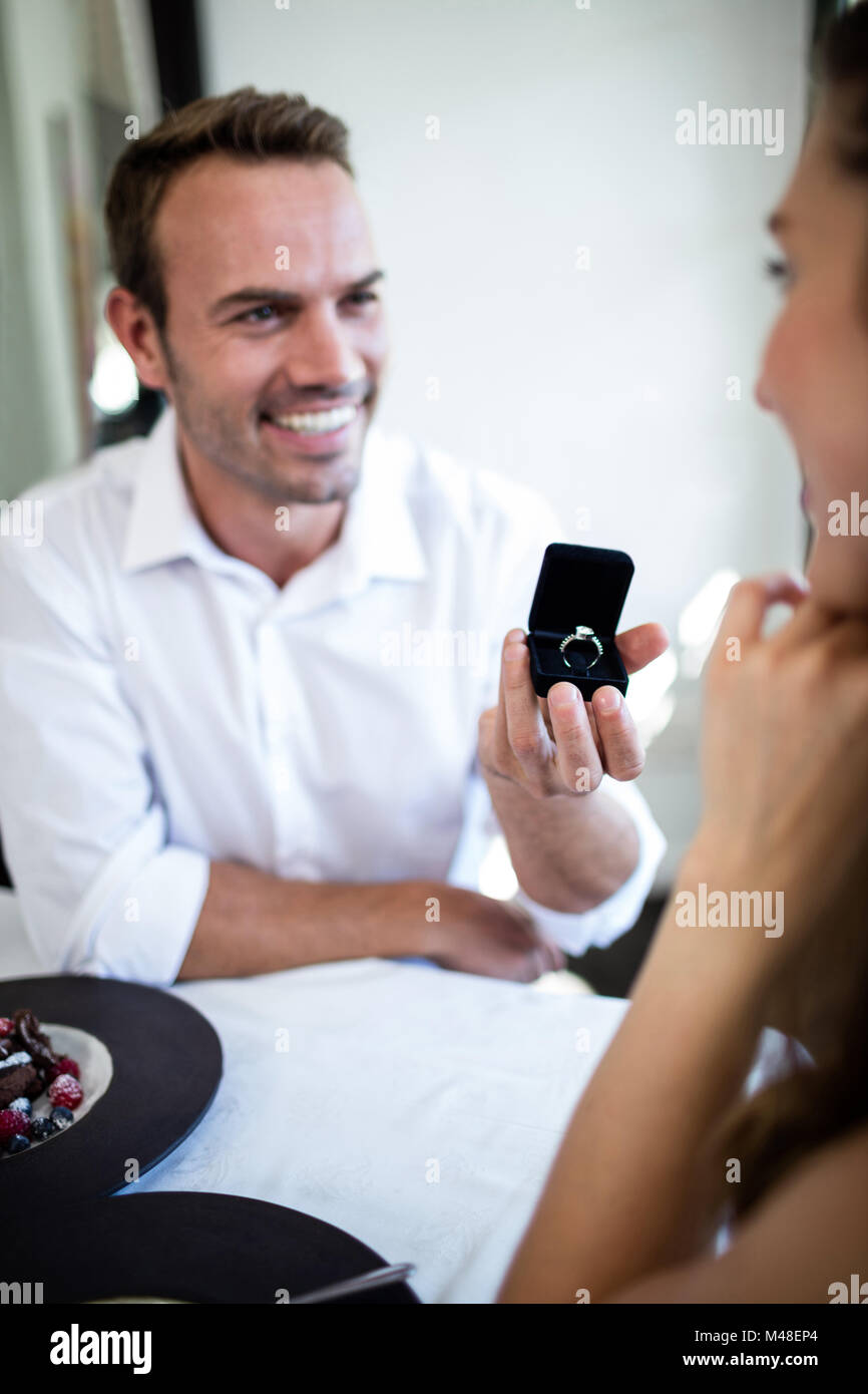 Man proposing to woman offering engagement ring Stock Photo - Alamy