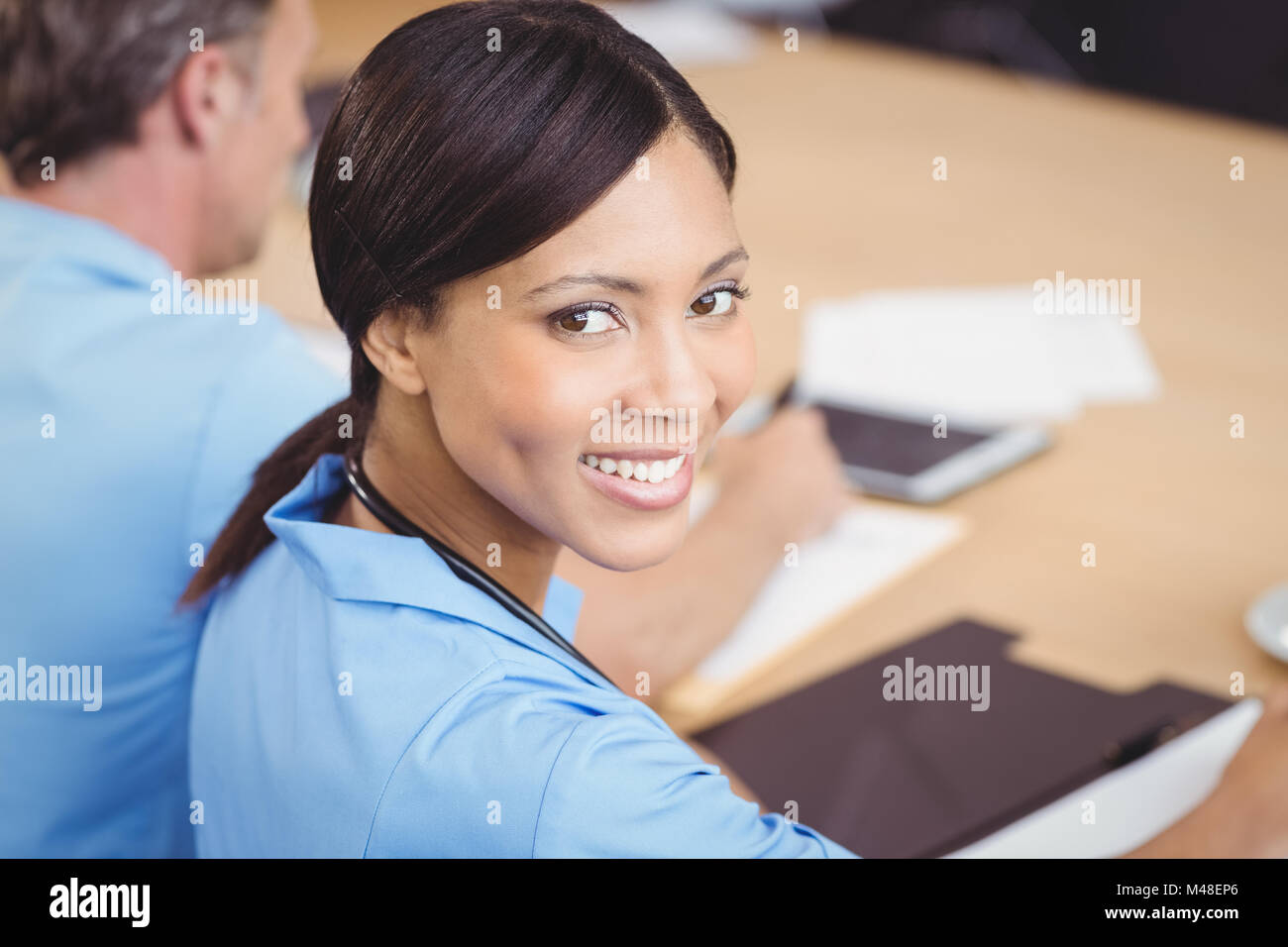 Happy female doctor sitting on conference room Stock Photo - Alamy