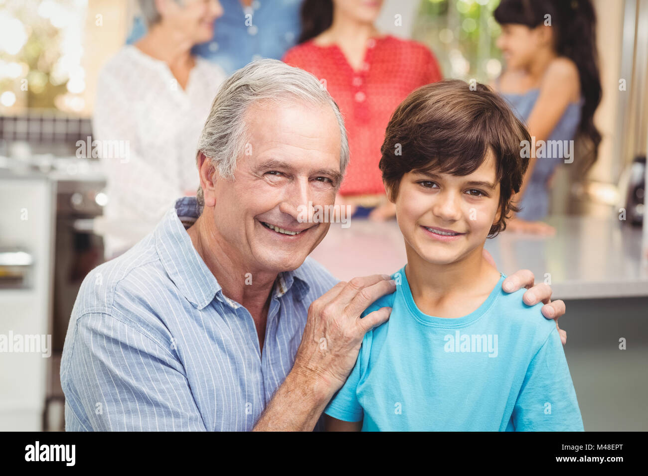 Portrait of grandfather and grandson with family Stock Photo - Alamy