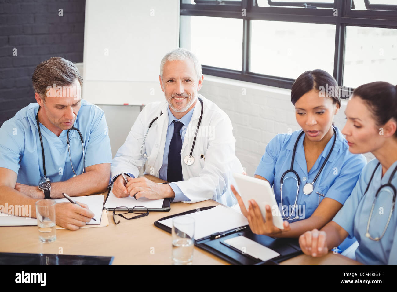Portrait of male doctor smiling in conference room Stock Photo - Alamy