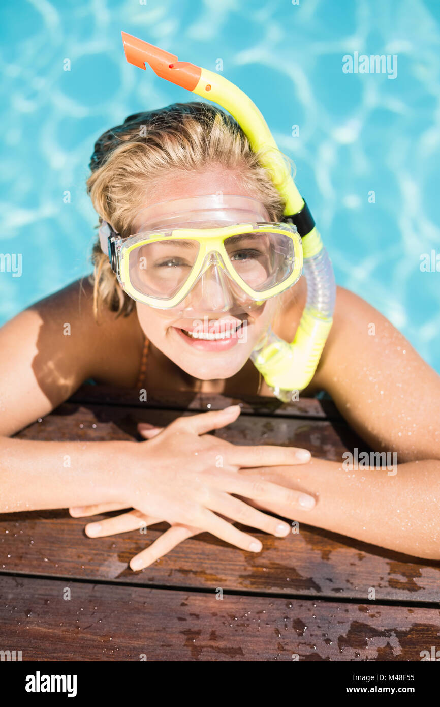 Happy woman with snorkel gear leaning on pool side Stock Photo - Alamy