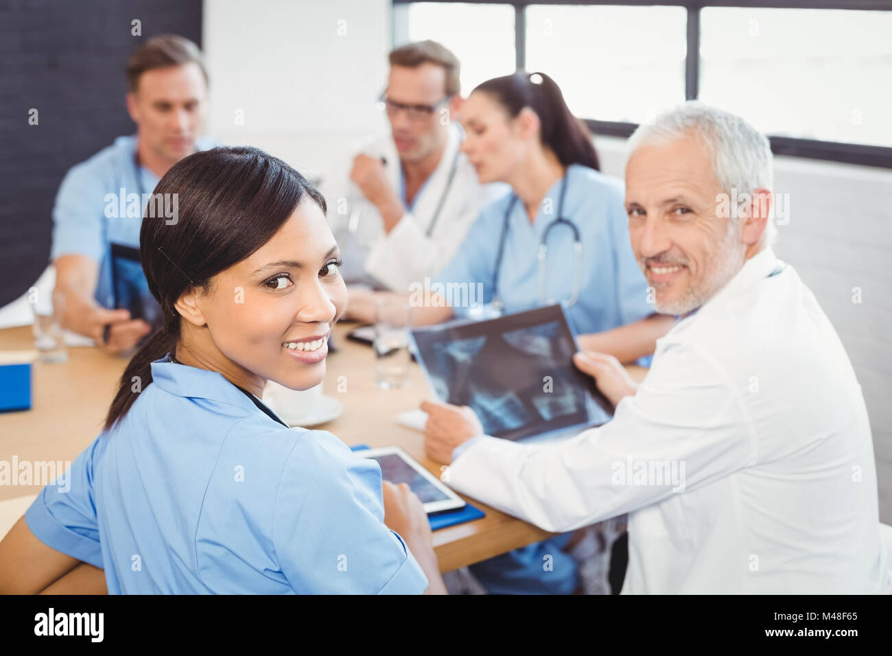 Portrait of doctors smiling in conference room Stock Photo - Alamy