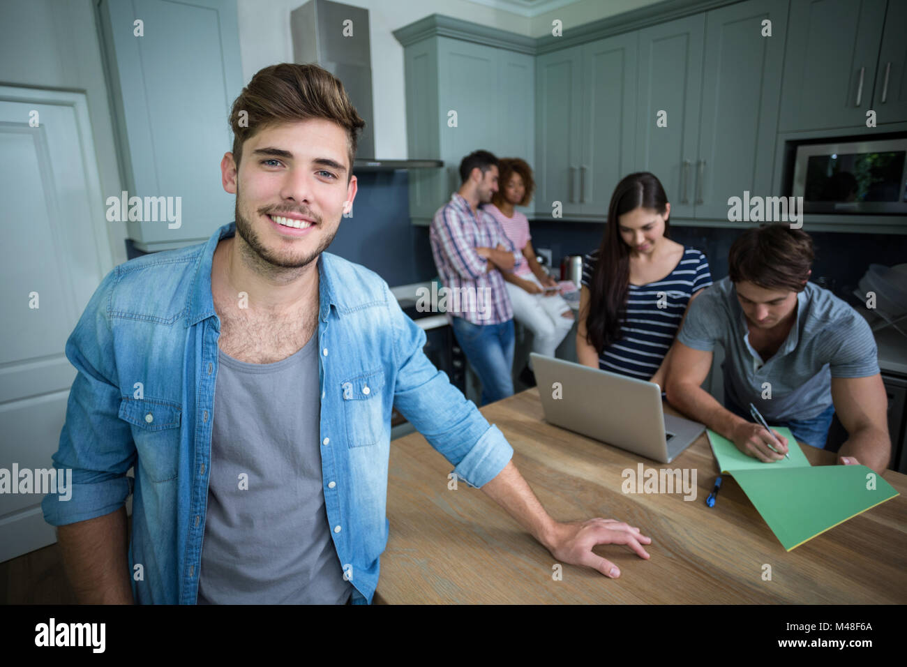 Portrait of smiling man with friends in background Stock Photo - Alamy