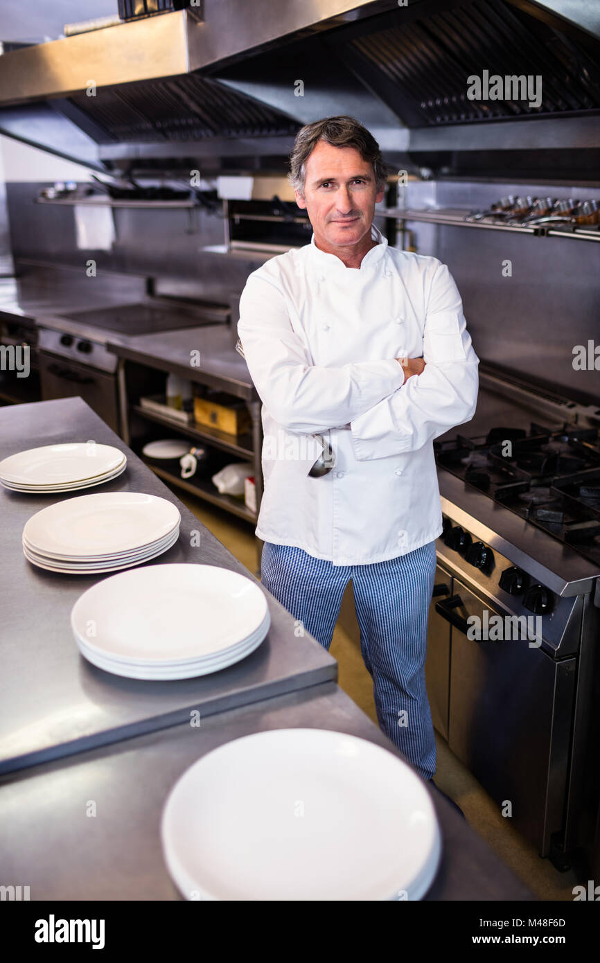 Smiling chef with hands crossed in the kitchen Stock Photo - Alamy