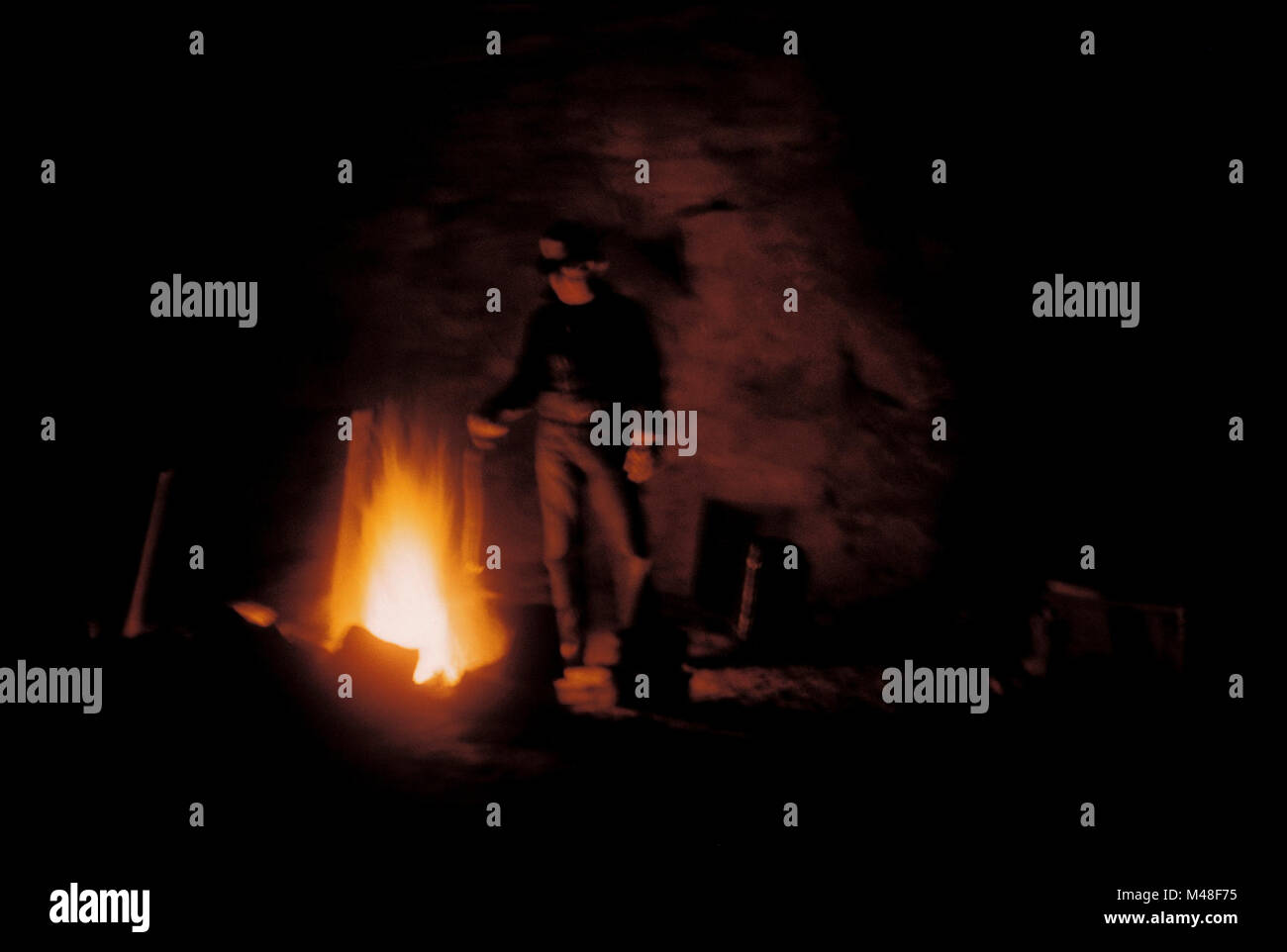 Bates Wilson tending fire Stock Photo - Alamy