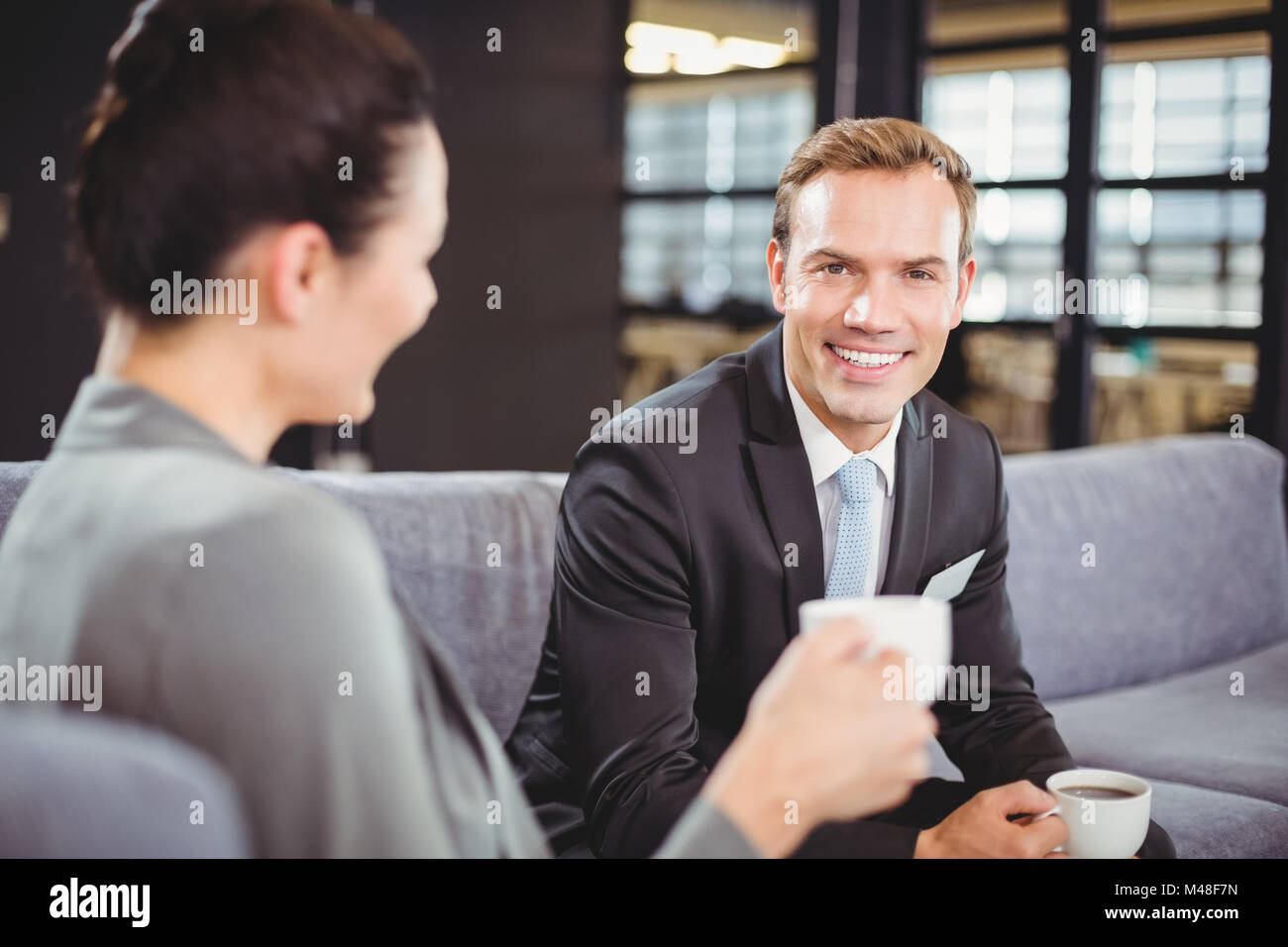 Businessman and businesswoman having tea during breaktime Stock Photo ...
