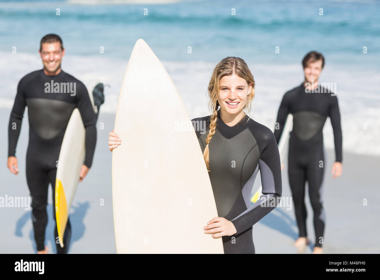 Portrait of surfer friends with surfboard standing on the beach Stock ...