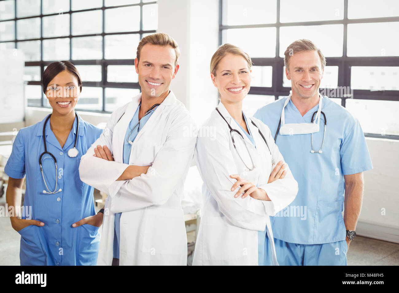 Happy medical team standing with arms crossed Stock Photo - Alamy
