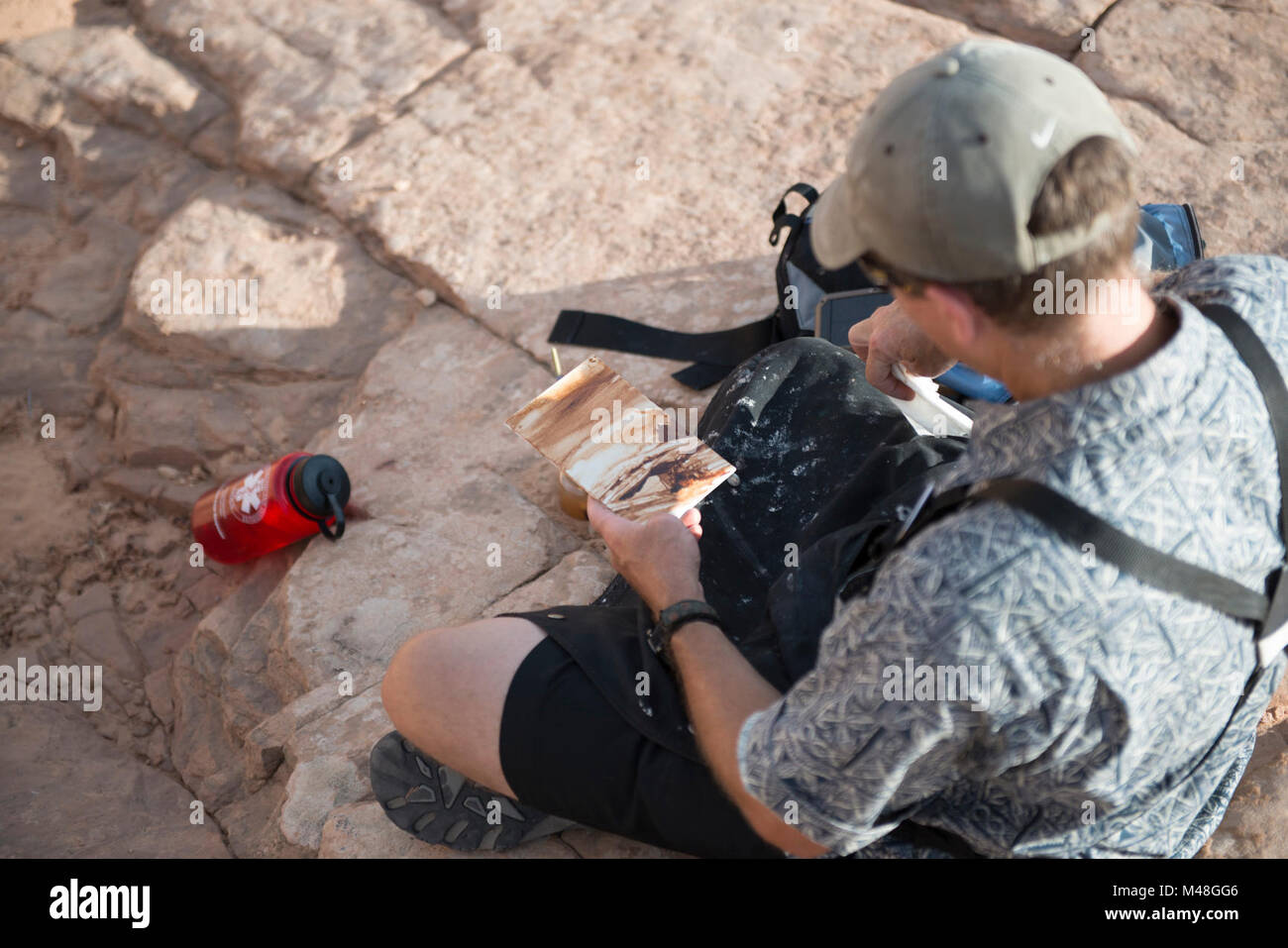 Community Artist Anthony Lott paints at Mesa Arch Stock Photo - Alamy