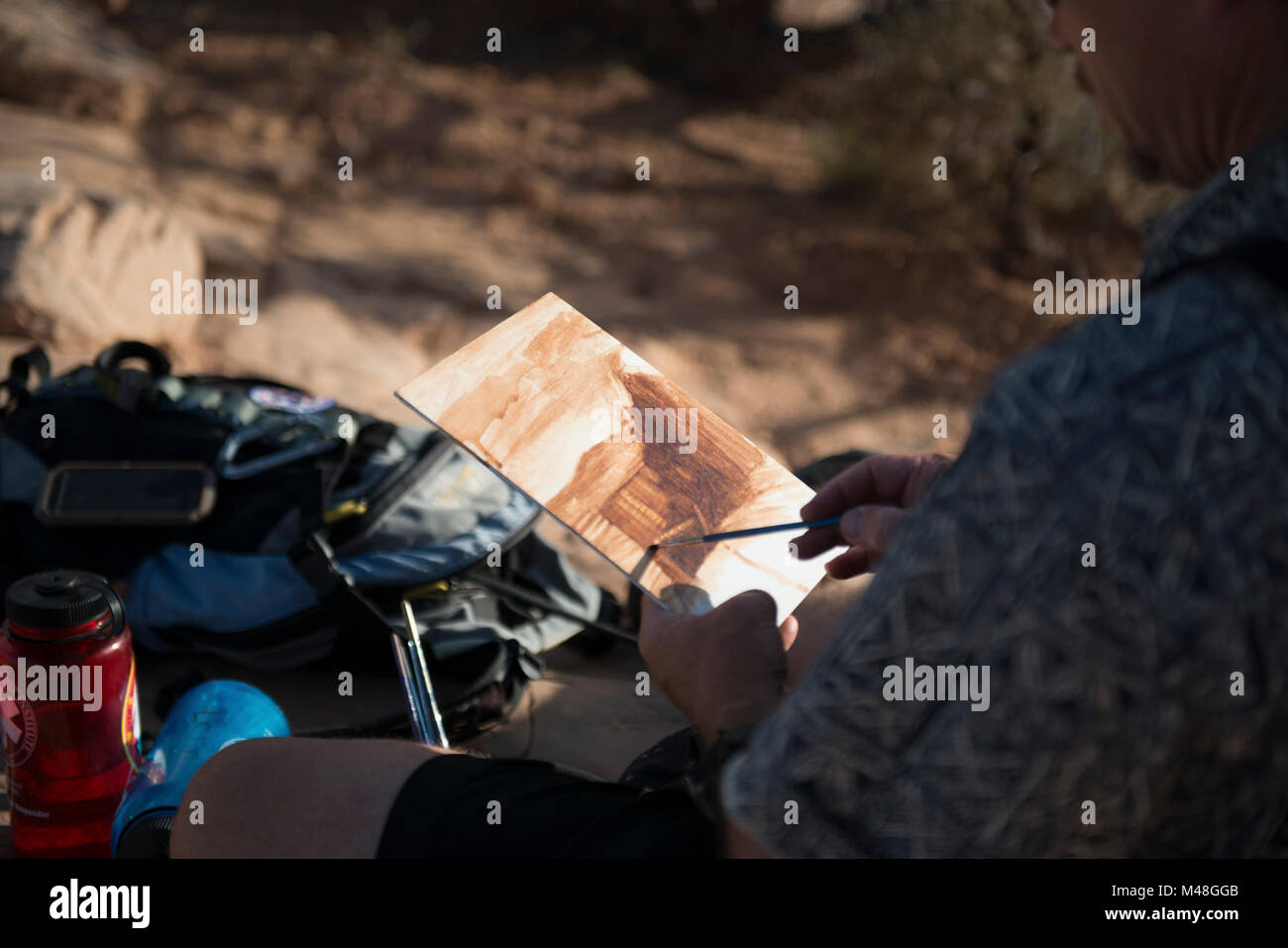 Community Artist Anthony Lott paints at Mesa Arch Stock Photo - Alamy