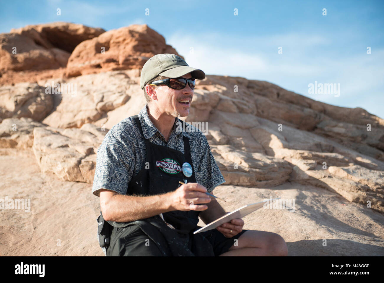 Community Artist Anthony Lott paints at Mesa Arch Stock Photo - Alamy