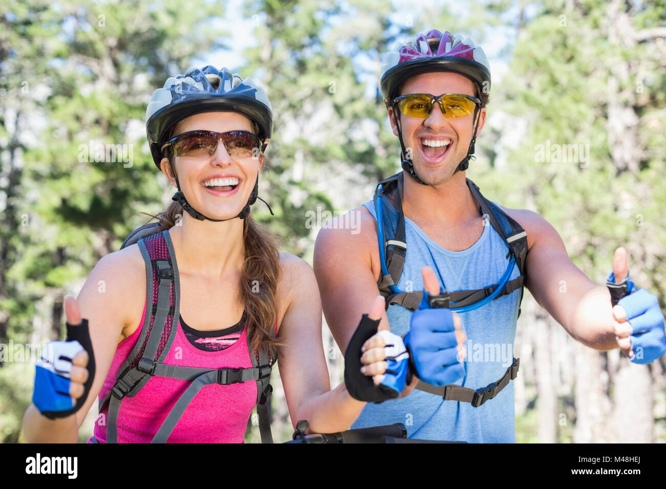 Portrait of young couple showing thumbs up sign Stock Photo - Alamy