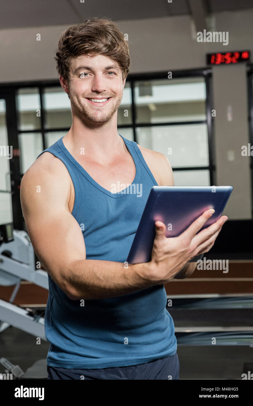 Portrait of gym trainer using a digital tablet Stock Photo - Alamy