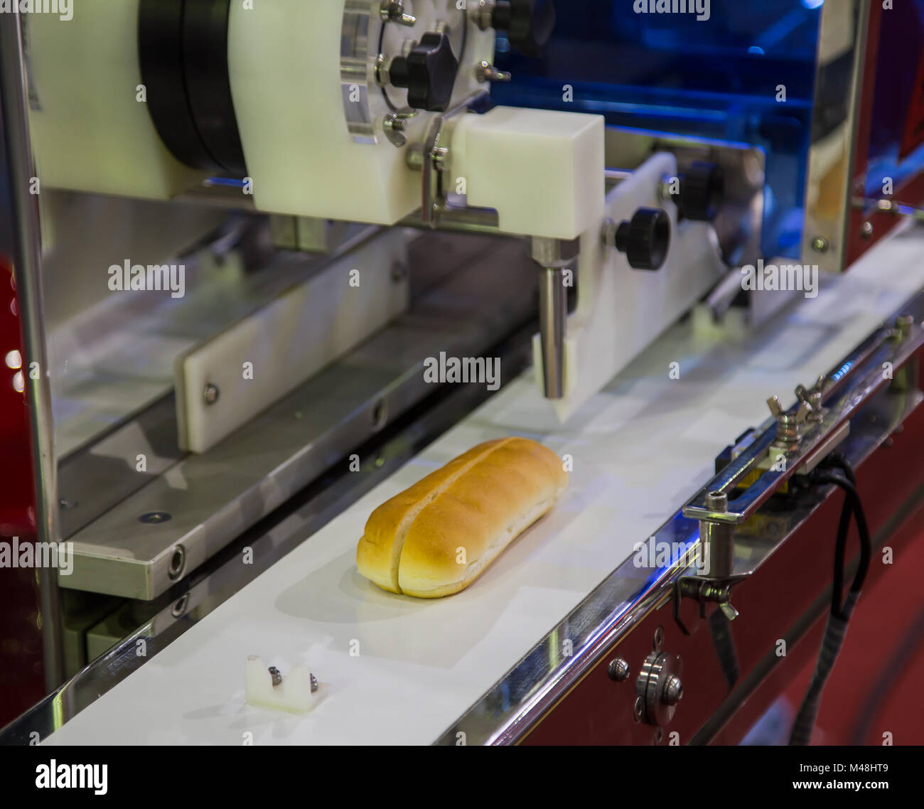 Automatic Bread/Toast/Bun cutting and filling machine Stock Photo - Alamy