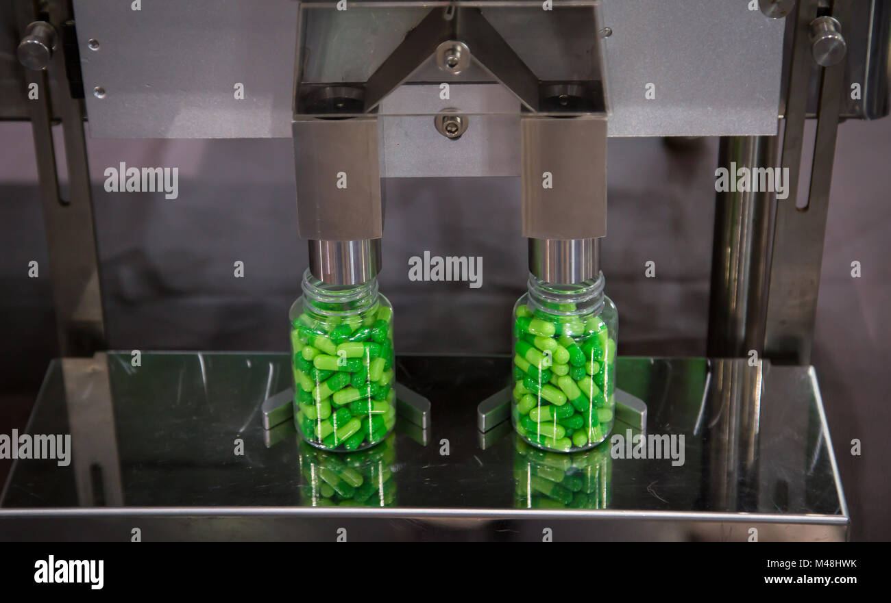 capsule pharmaceutical pills counting and filling machine Stock Photo ...