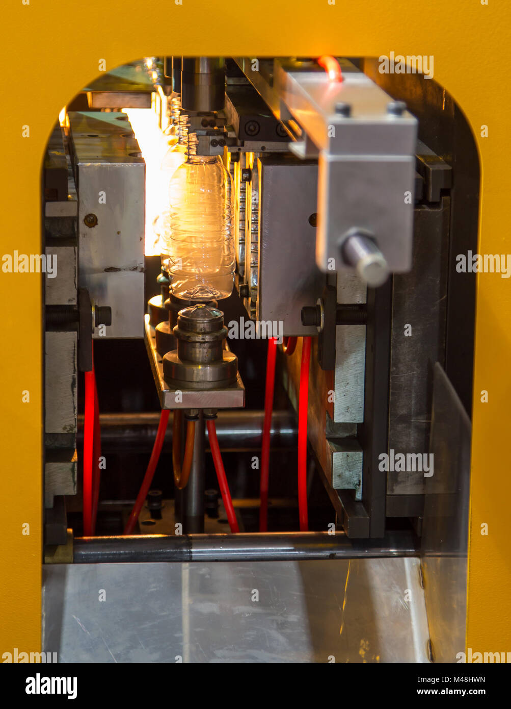 Heating process for plastic bottle blowing machine Stock Photo - Alamy