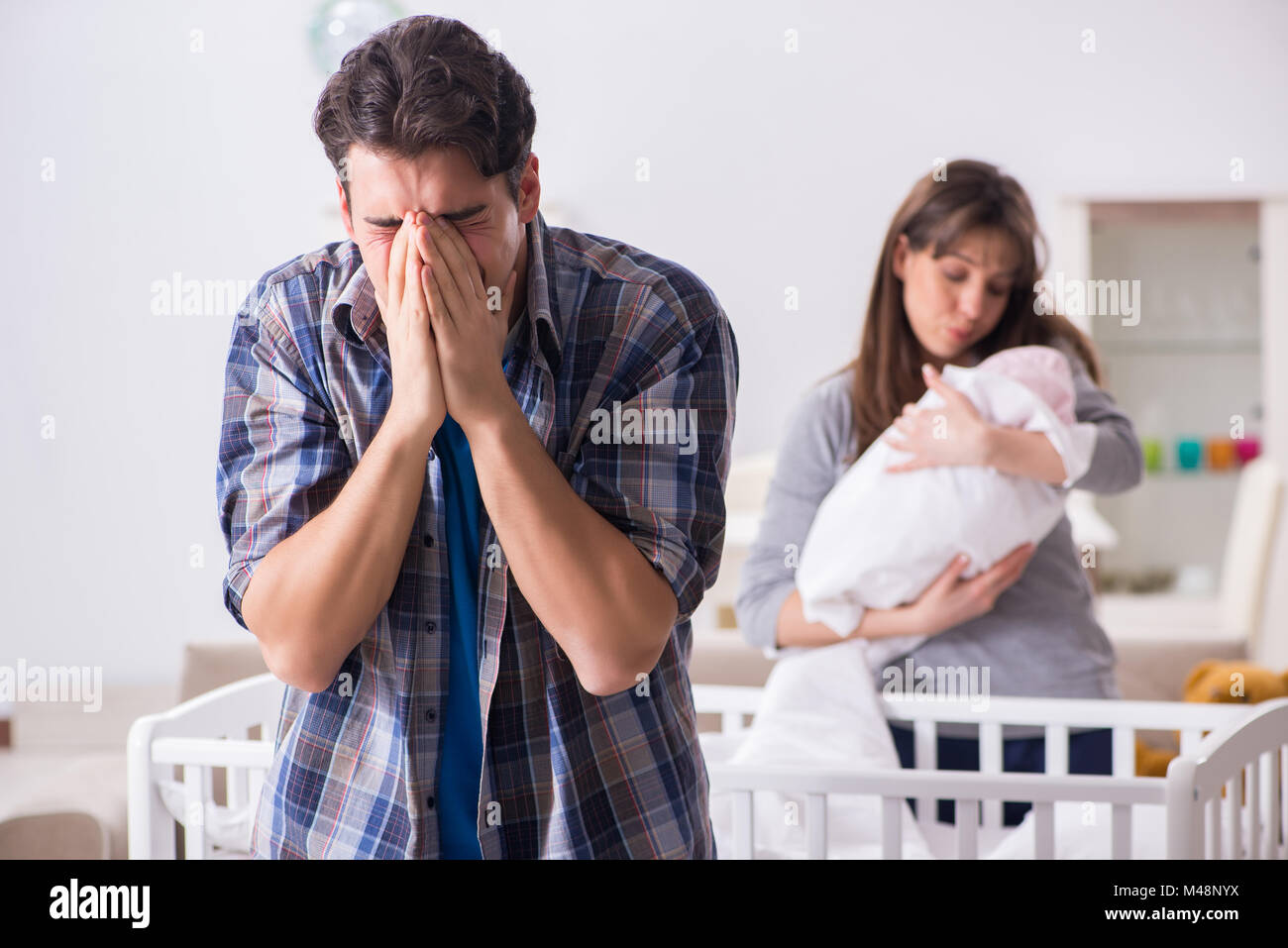 Young dad cannot stand baby crying Stock Photo - Alamy