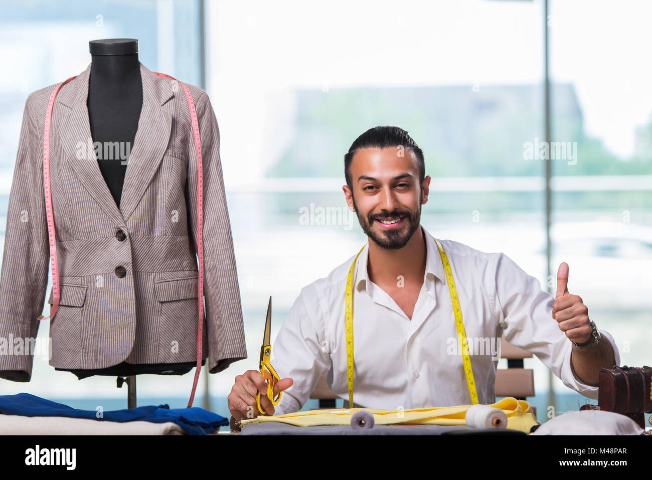 The young tailor working on new clothing design Stock Photo - Alamy