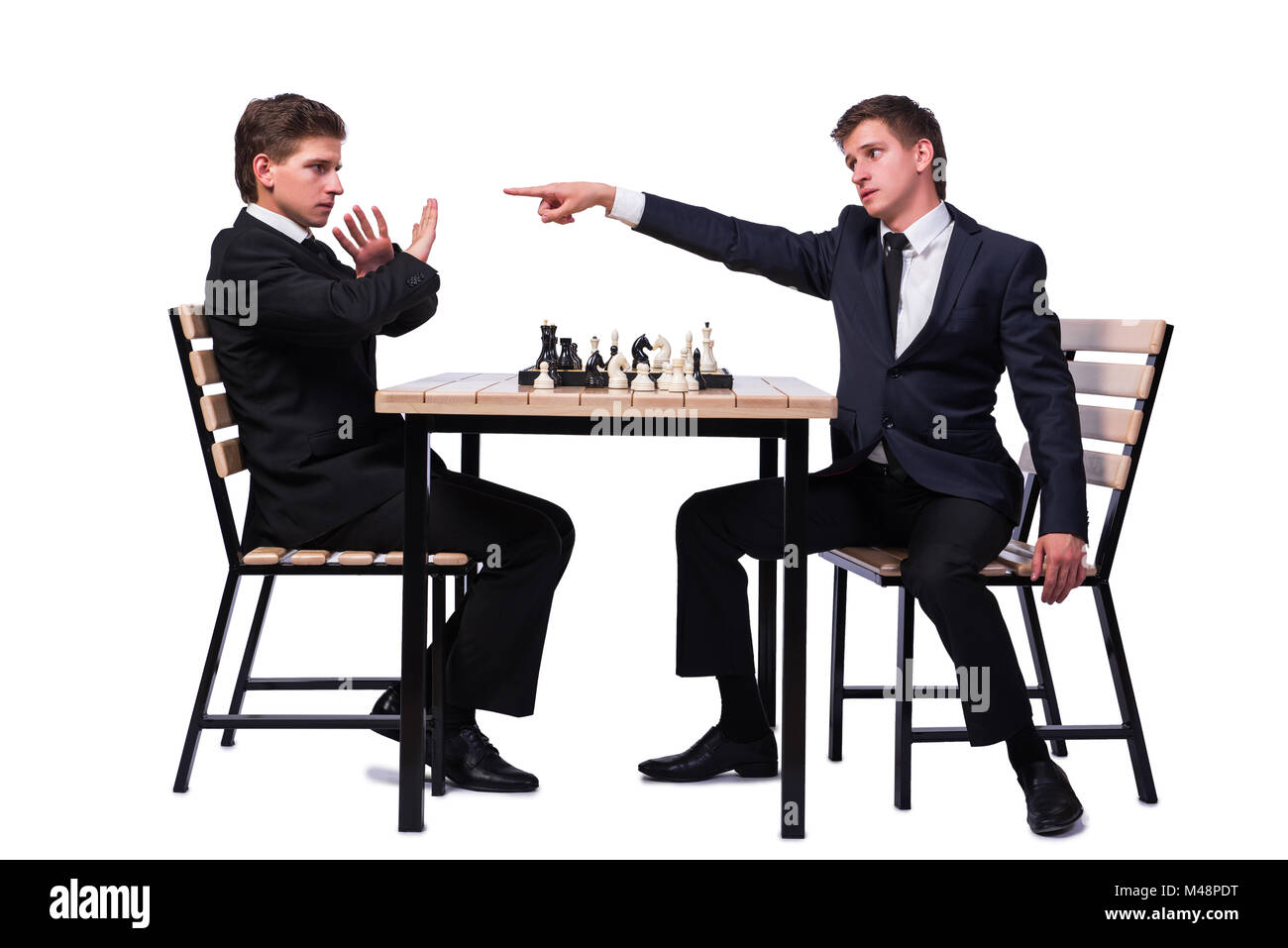 The twin brothers playing chess isolated on white Stock Photo - Alamy