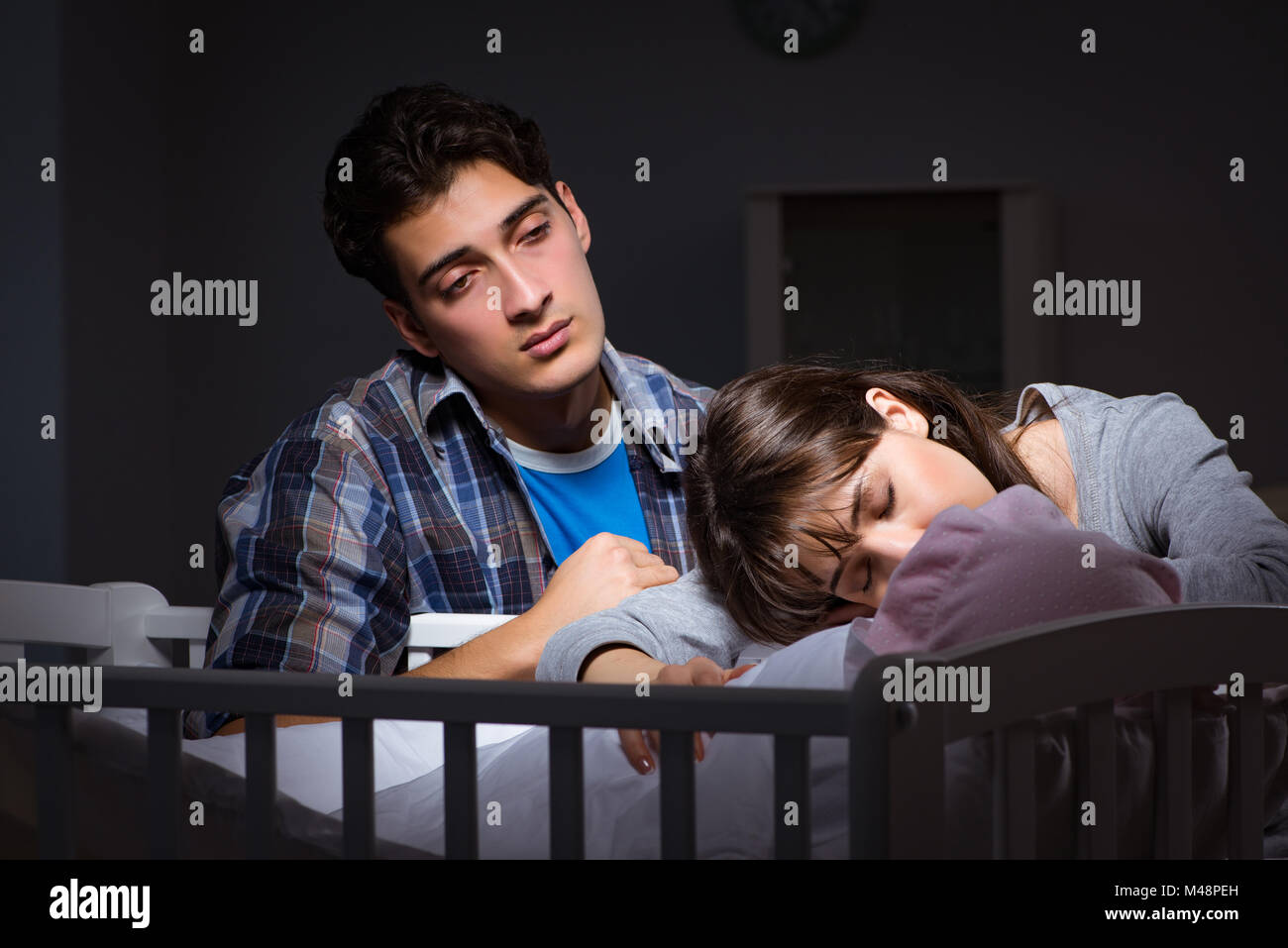 Young parents sleepless with newborn baby at night Stock Photo - Alamy