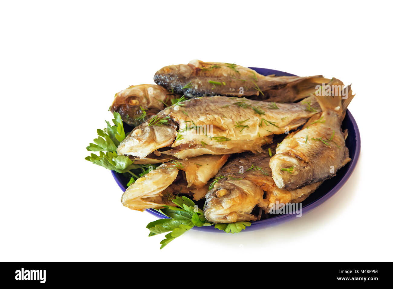 Roasted carp on a plate on a white background Stock Photo - Alamy