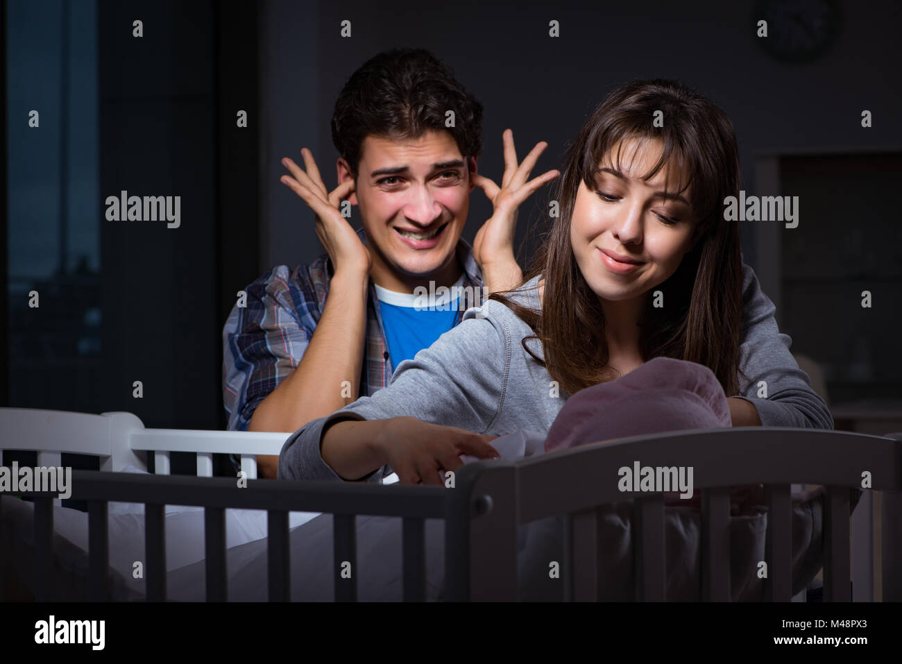 Young parents sleepless with newborn baby at night Stock Photo - Alamy