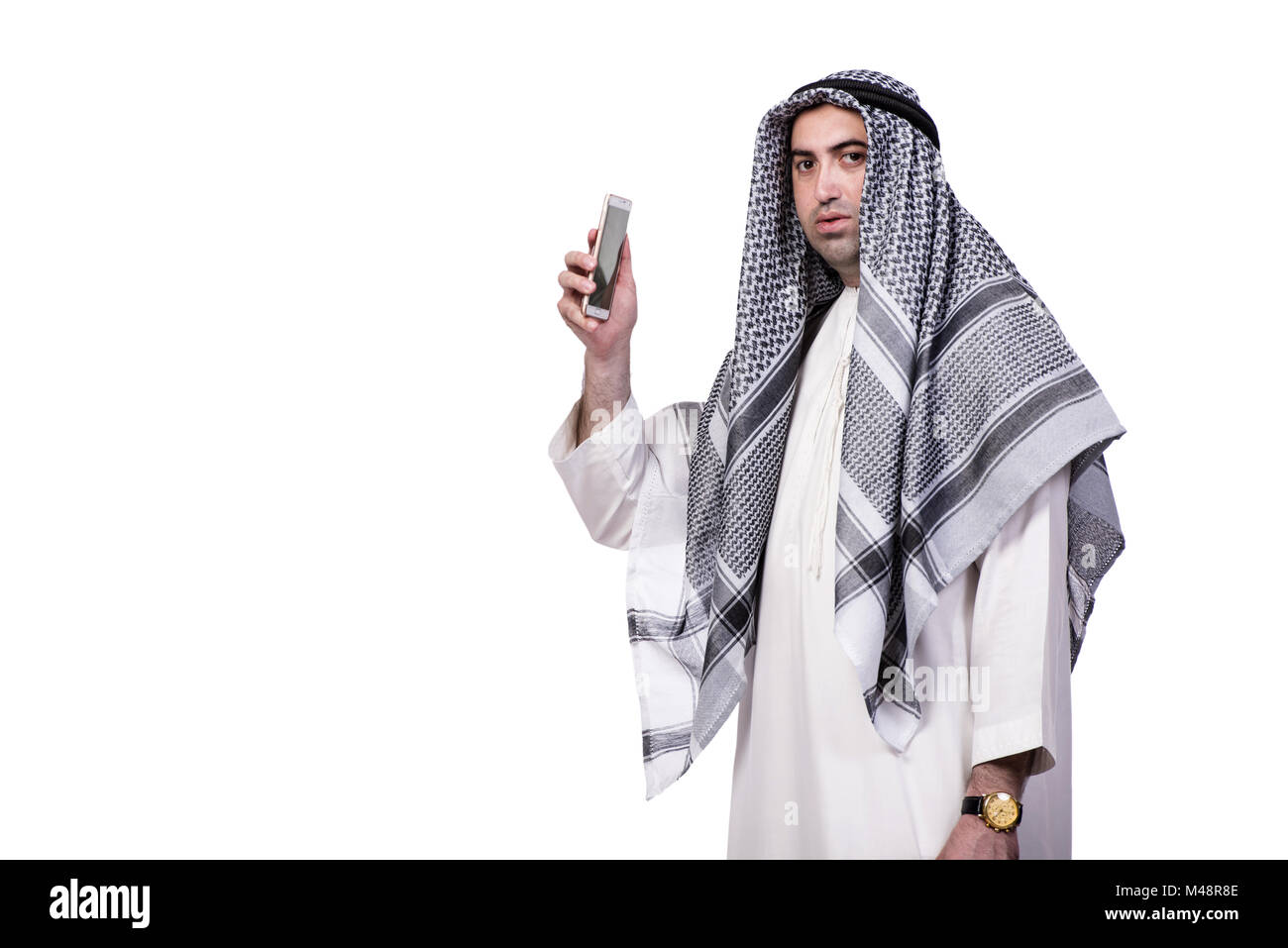Arab man with his mobile phone isolated on white Stock Photo - Alamy