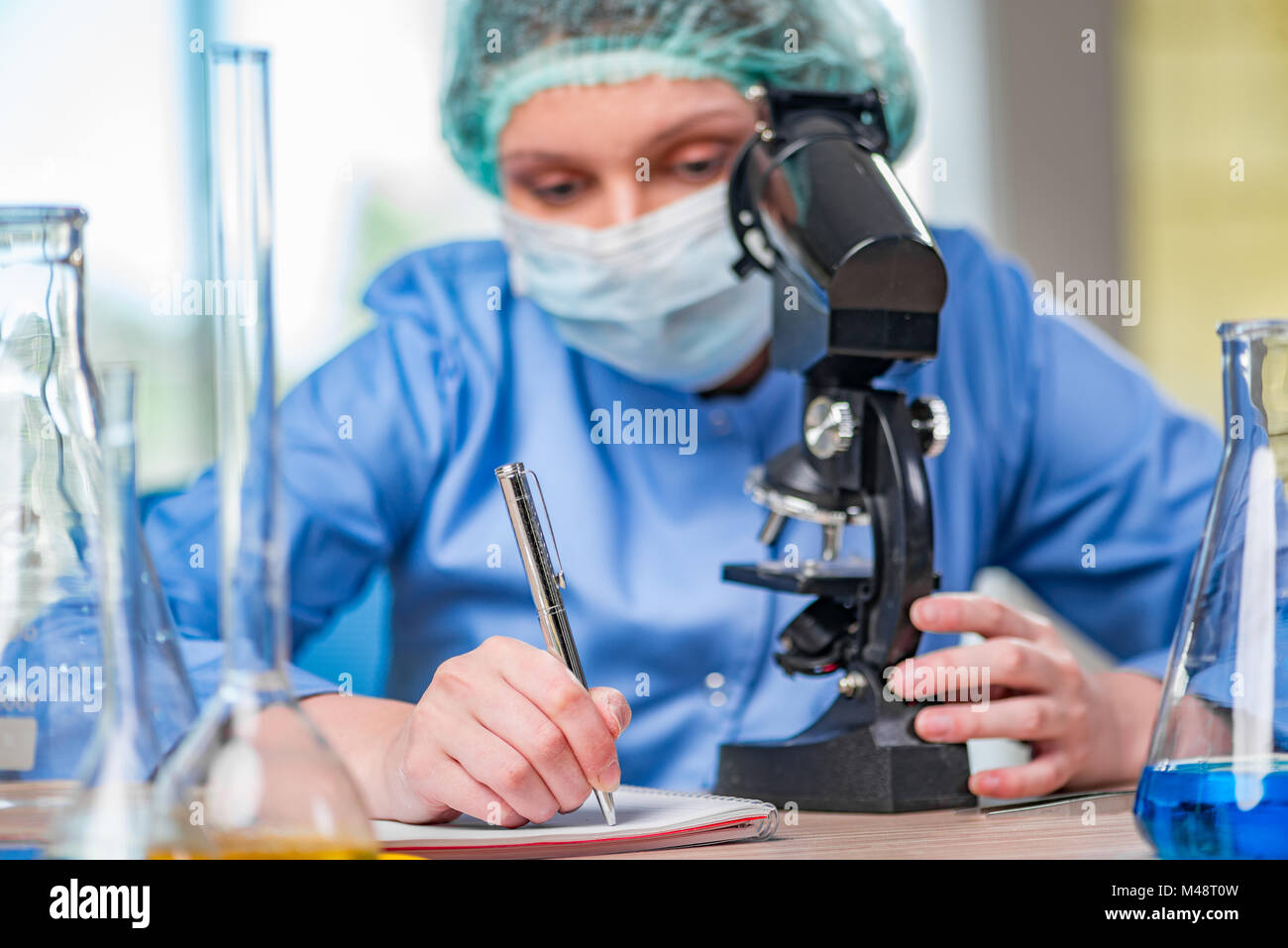 Experienced lab assistant working on chemical solutions Stock Photo - Alamy