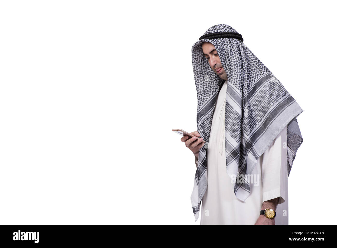 Arab man with his mobile phone isolated on white Stock Photo - Alamy