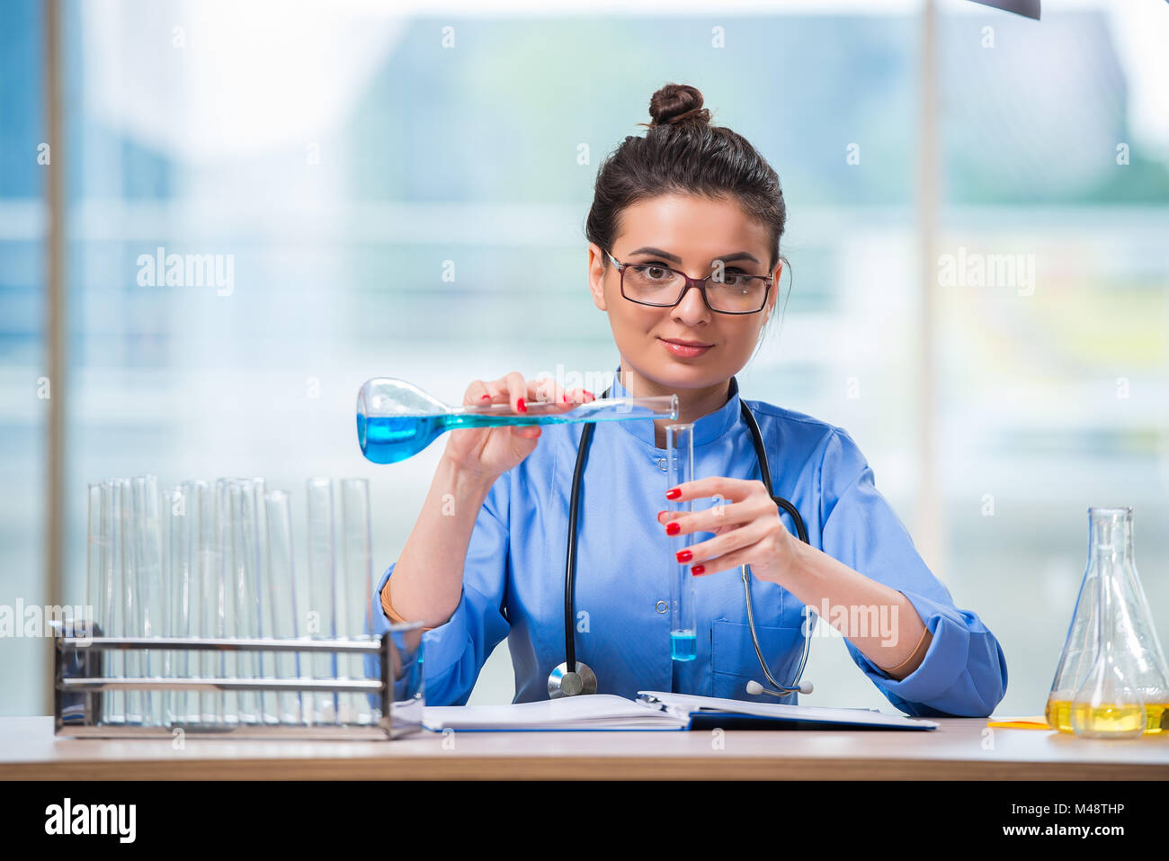 Woman doctor doing chemical tests in laboratory Stock Photo - Alamy