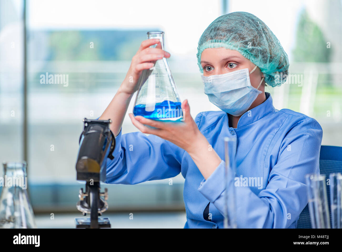 Experienced lab assistant working on chemical solutions Stock Photo - Alamy