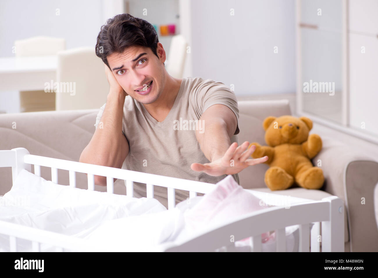 Young father dad frustrated at crying baby Stock Photo - Alamy