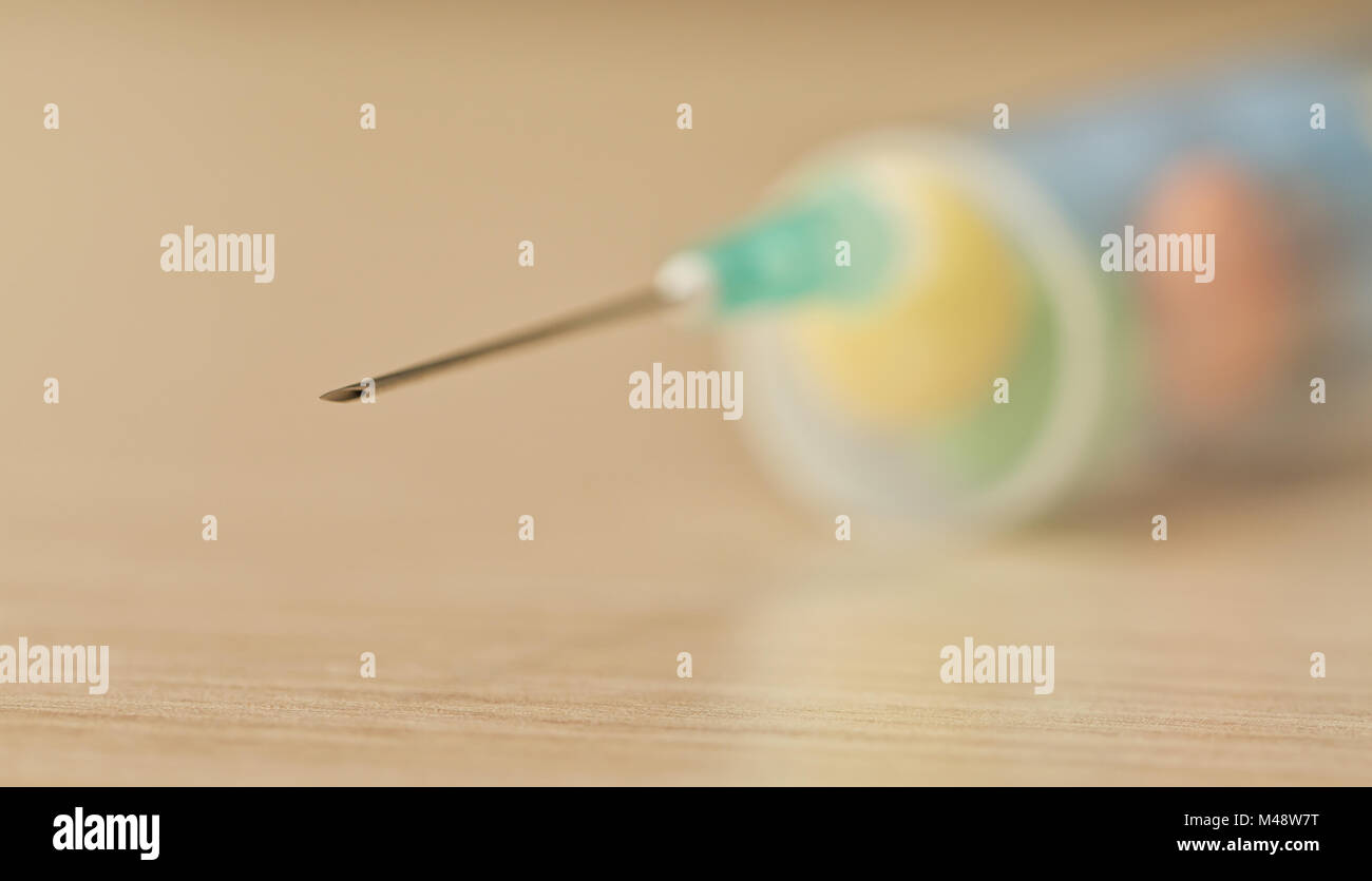 The syringe is charged by injection of sweets Stock Photo - Alamy