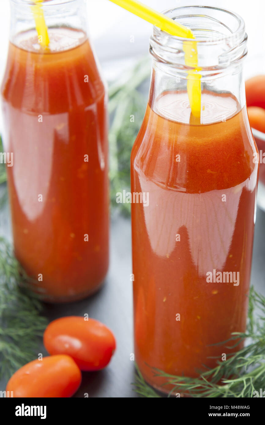 Natural and fresh tomato juice in small bottles Stock Photo - Alamy