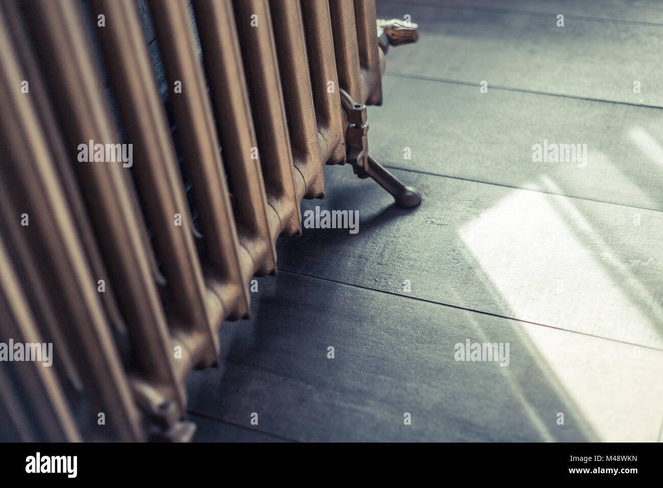old vintage heating radiator with valve Stock Photo - Alamy